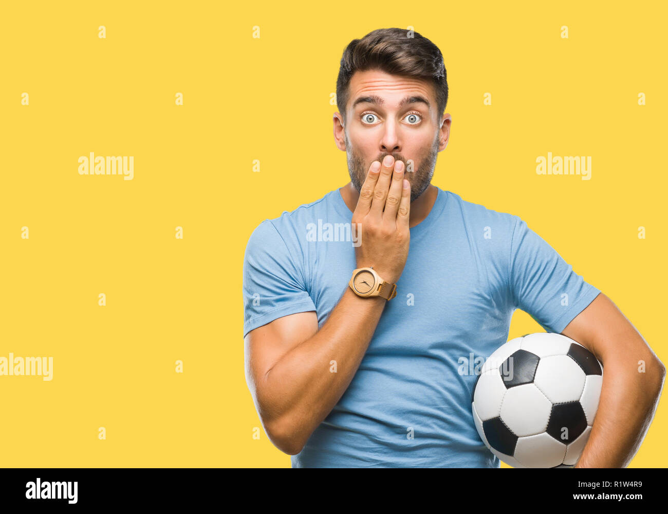 Young handsome man holding soccer football ball over isolated ...