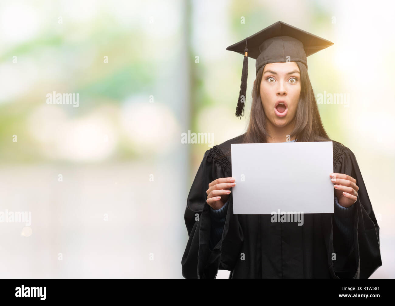 Sad college graduate holding diploma hi-res stock photography and ...