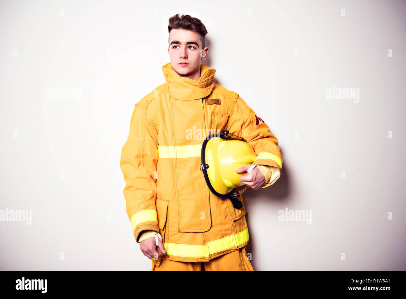 A Picture from a young and successful firefighter on studio Stock Photo ...