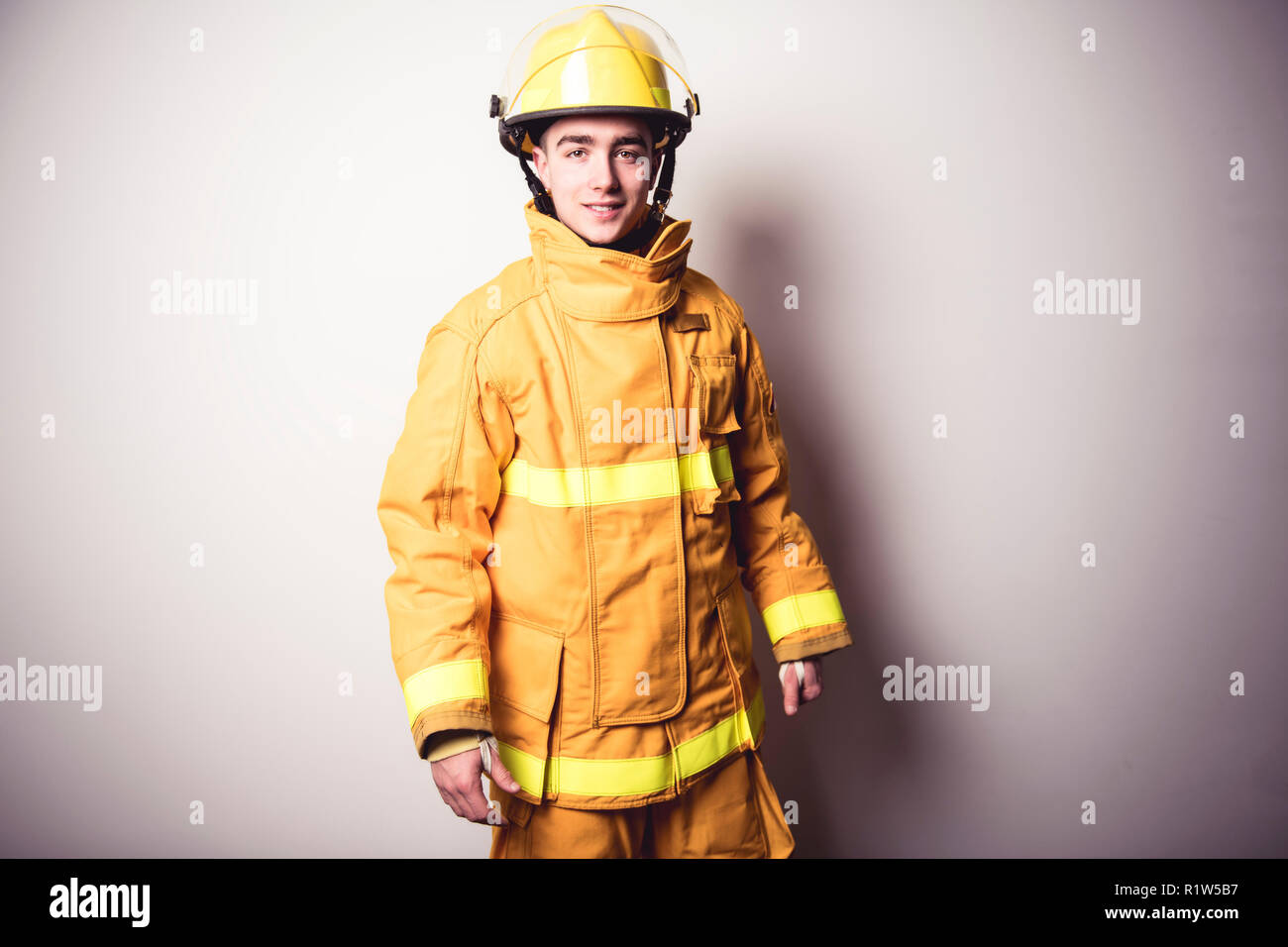 A Picture from a young and successful firefighter on studio Stock Photo ...