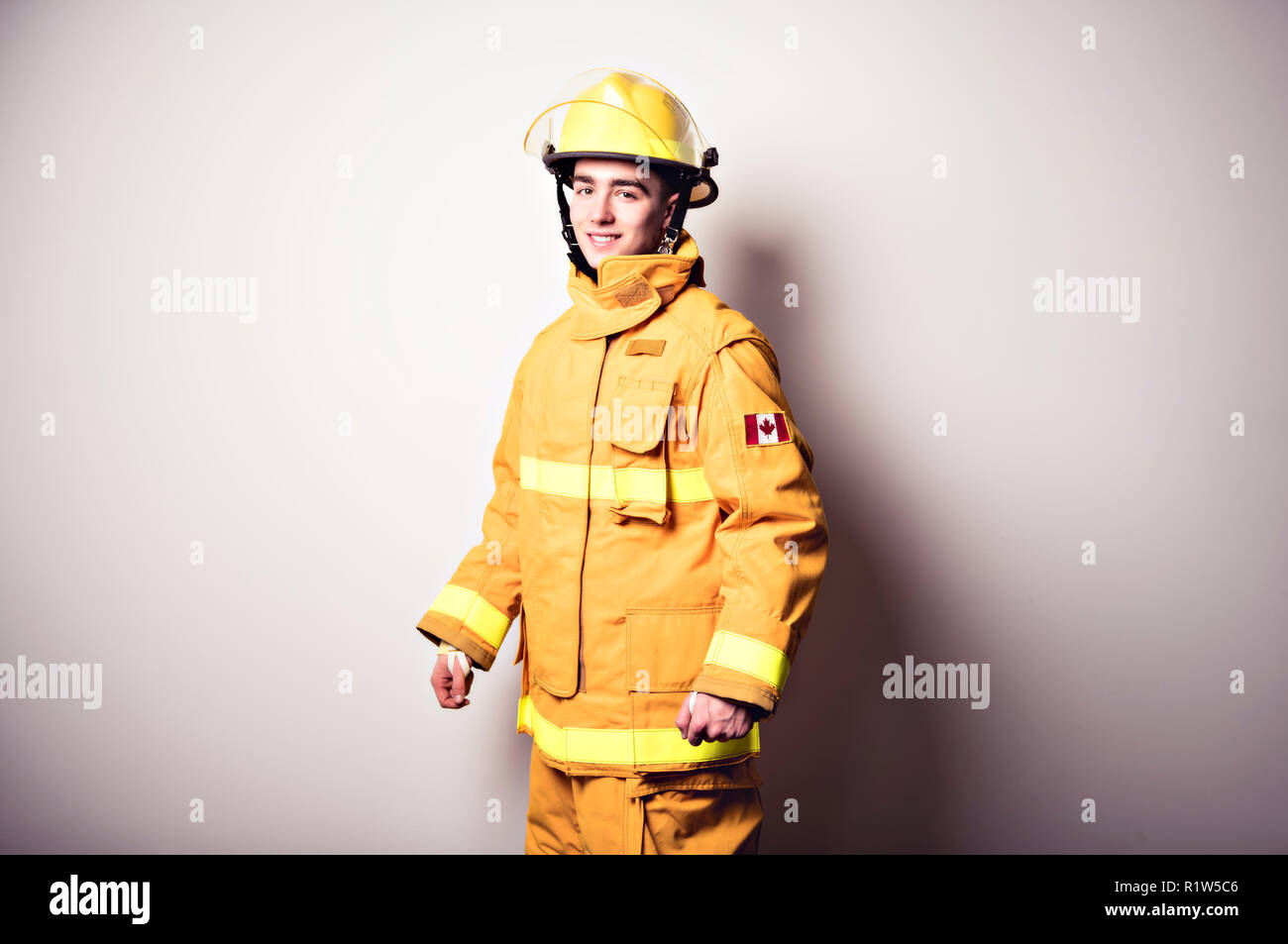 A Picture from a young and successful firefighter on studio Stock Photo ...