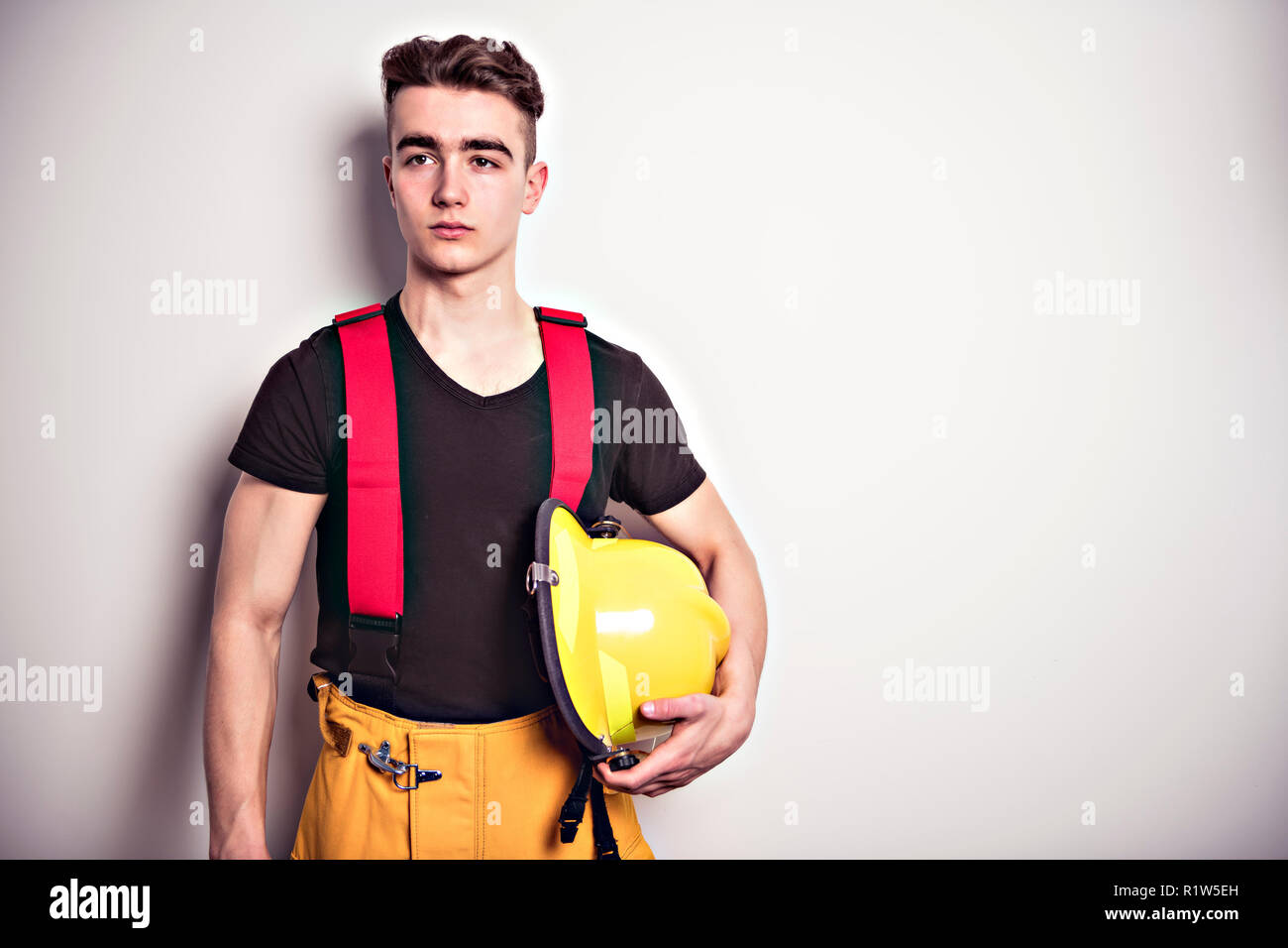A Picture from a young and successful firefighter on studio Stock Photo ...