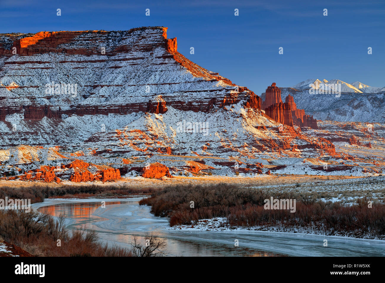 Red rock formations and Colorado River with snow in winter near sunset ...