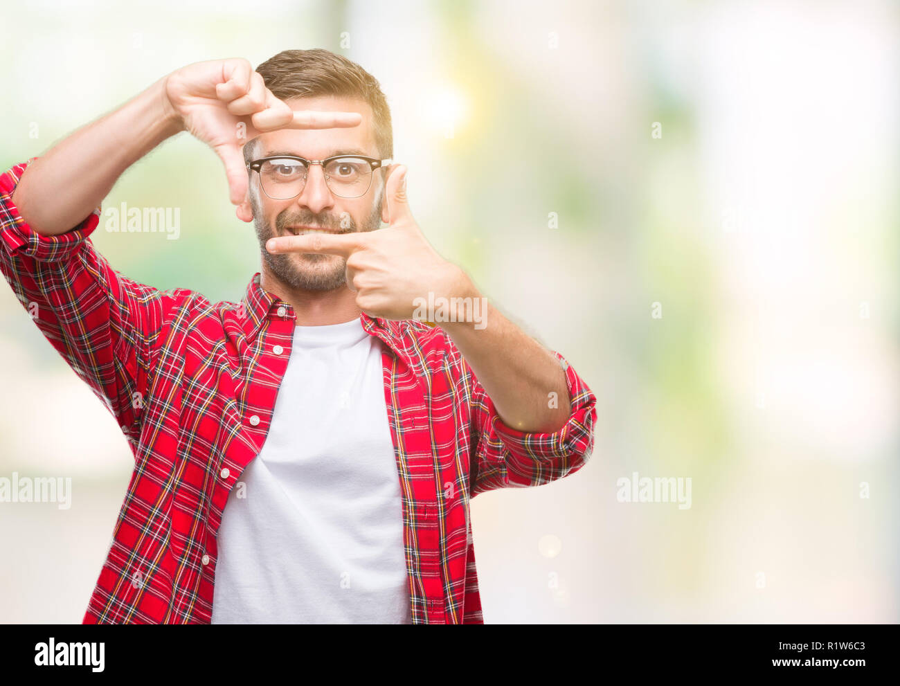 Young handsome man over isolated background smiling making frame with ...