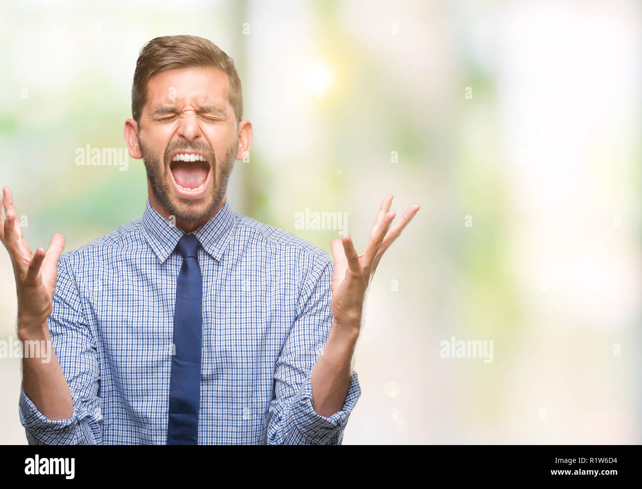 Young handsome business man over isolated background celebrating mad and crazy for success with ...