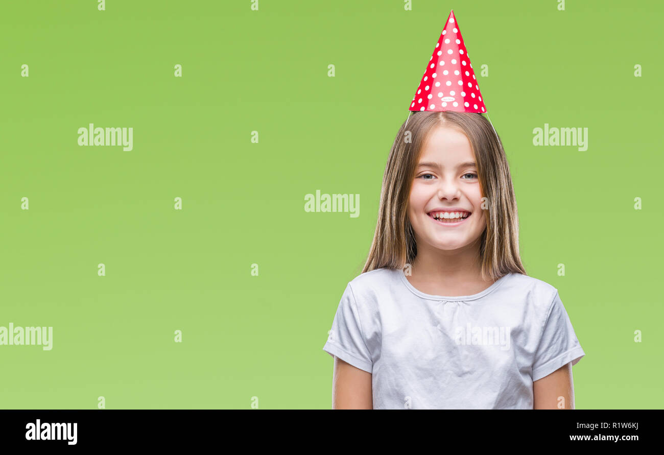 Young beautiful girl wearing birthday cap over isolated background with ...
