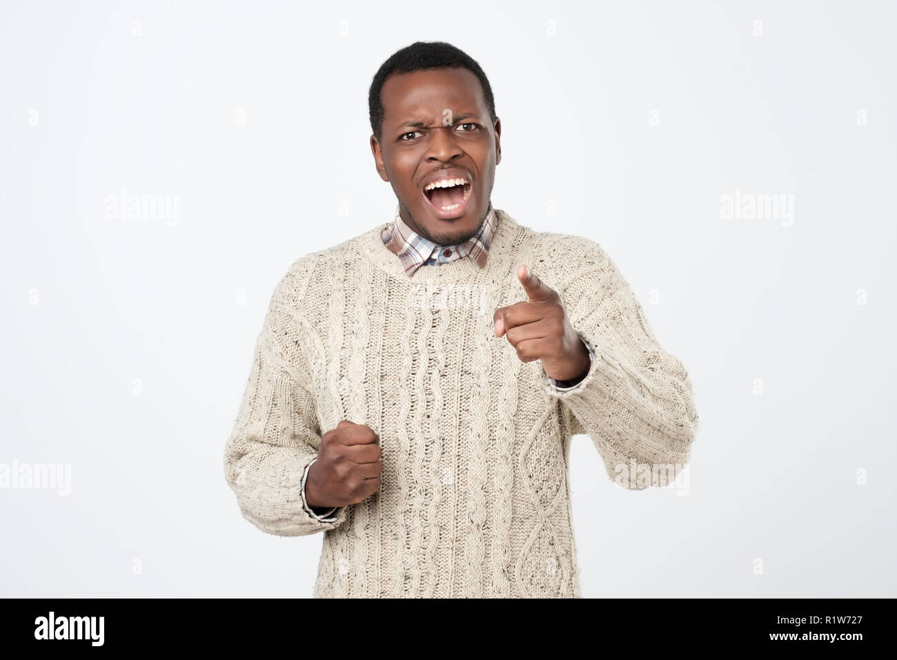 Disturbed displeased african man gestures angrily, has irritated ...