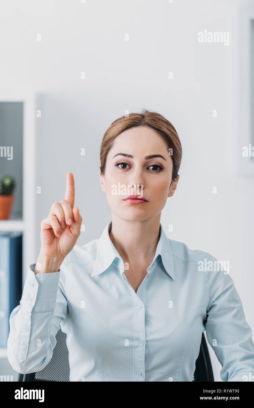 Woman pointing camera working on hi-res stock photography and images ...