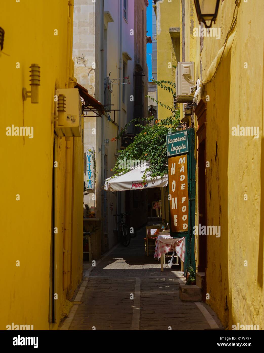 Cafe located on narrow street in old town Rethimno, Crete Stock Photo ...