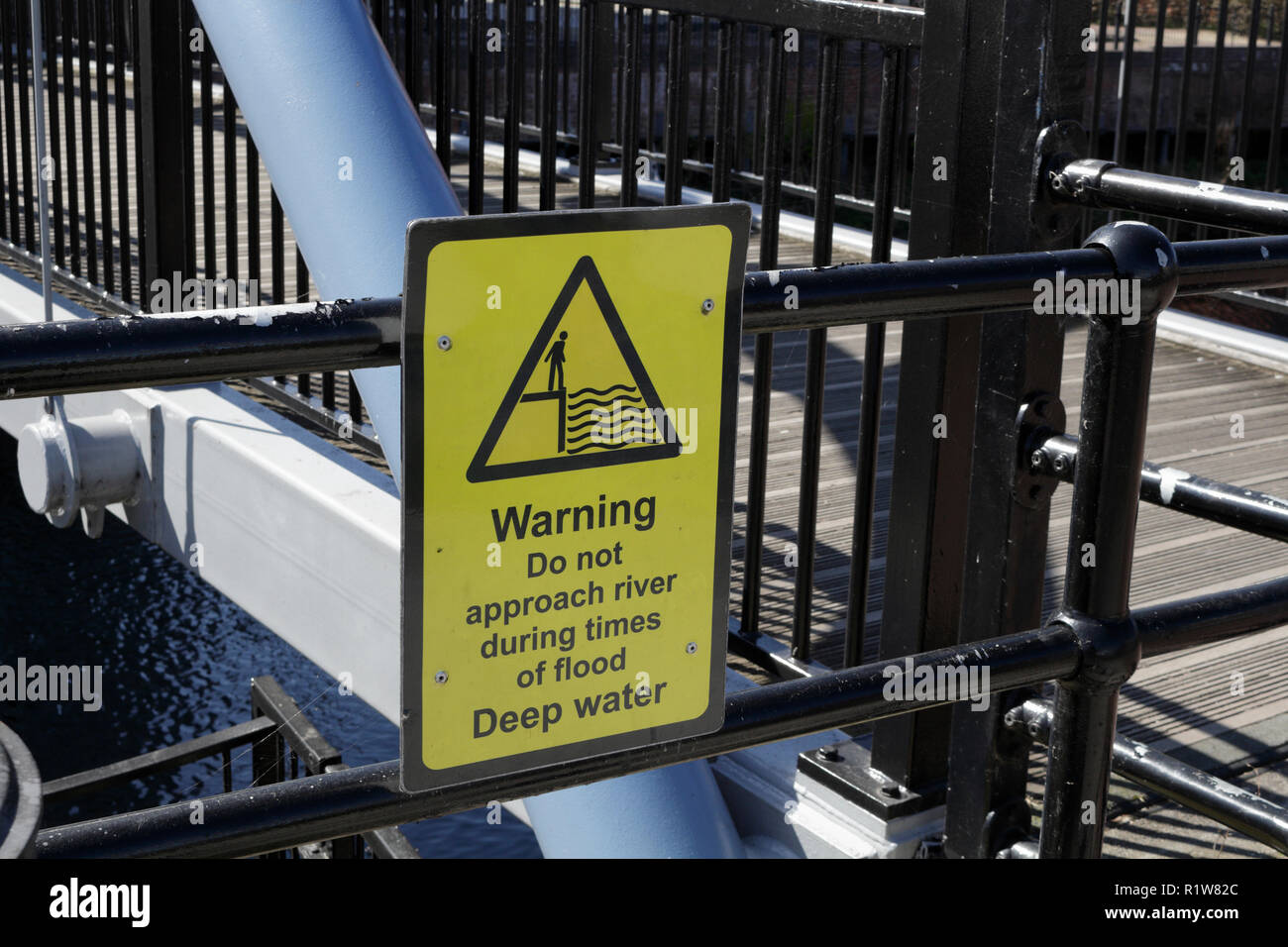 Warning sign about approaching river bank when flooding Stock Photo - Alamy
