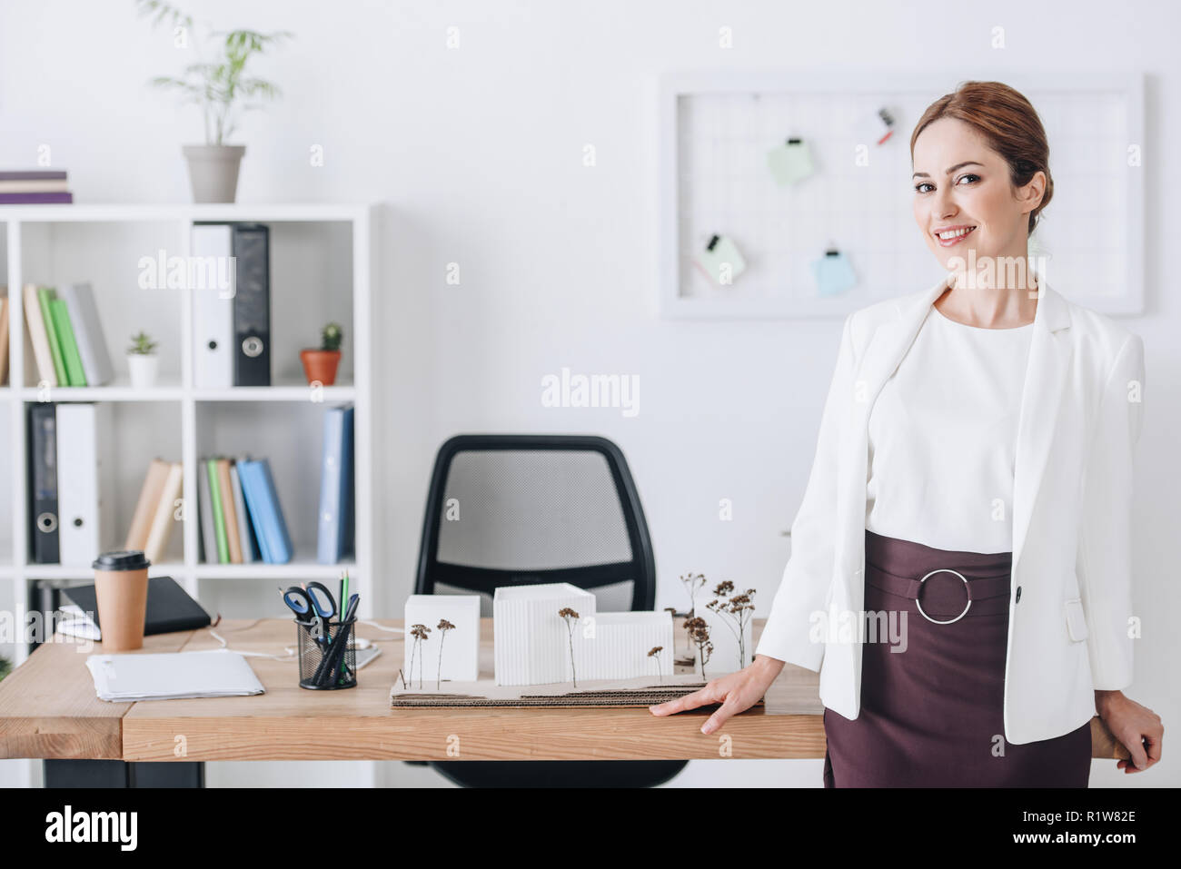 beautiful female architect posing at workplace with house model Stock ...