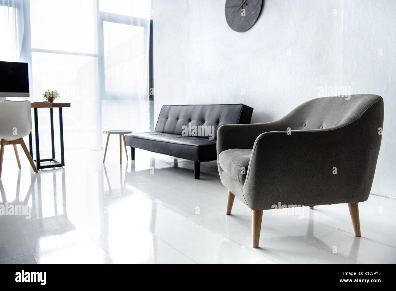 interior of modern living room with computer monitor on table, armchair ...