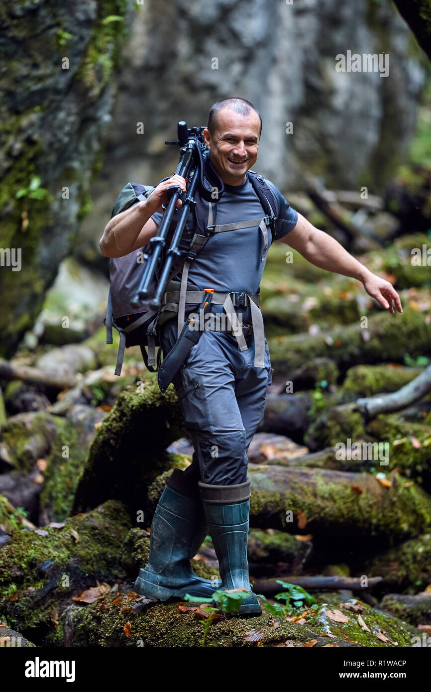 Professional nature photographer in a canyon by the river Stock Photo ...