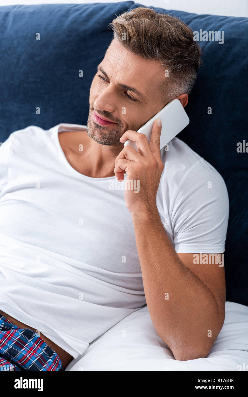 Happy man laying on bed hi-res stock photography and images - Alamy