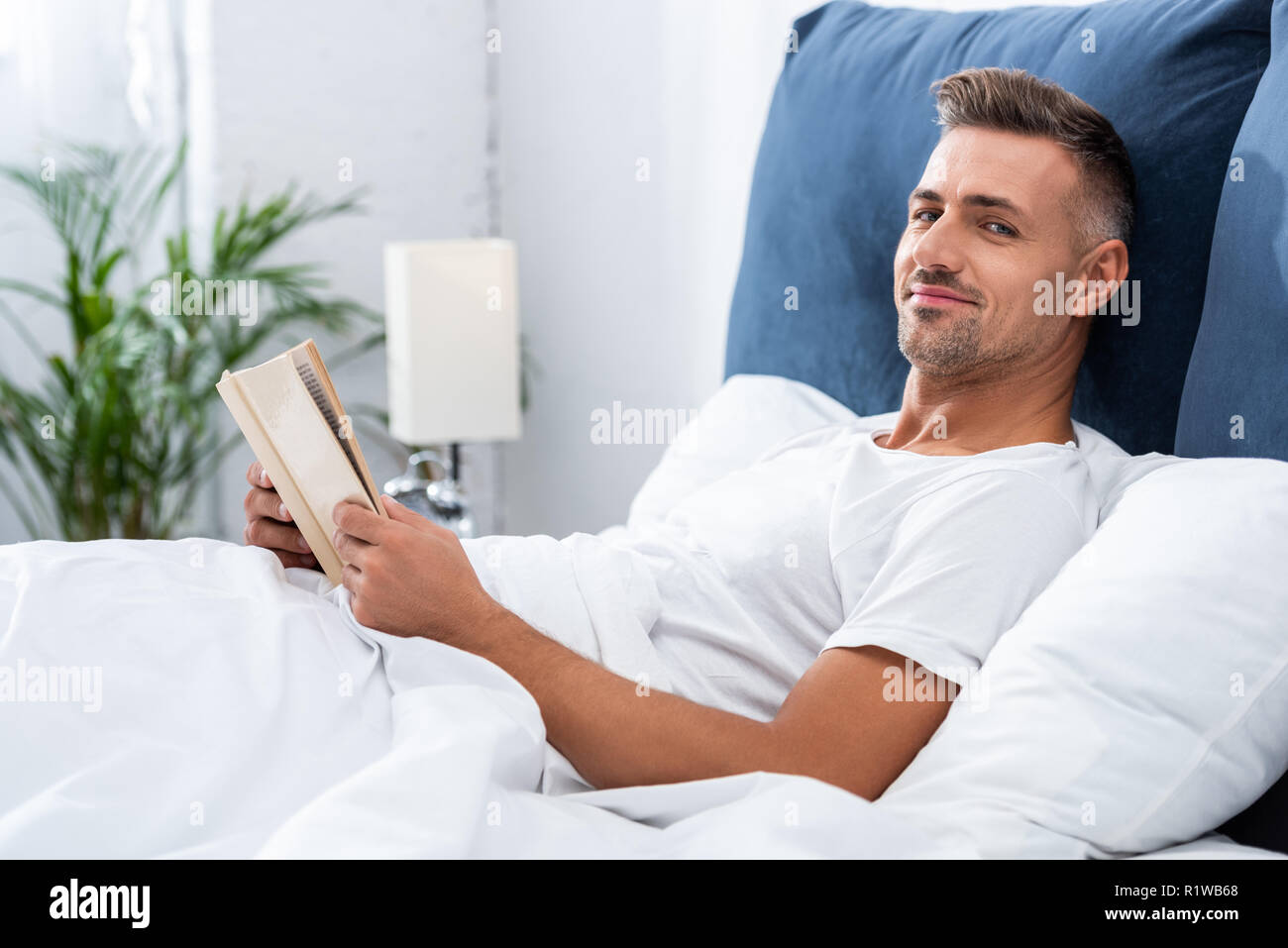 Happy man reading book hi-res stock photography and images - Alamy