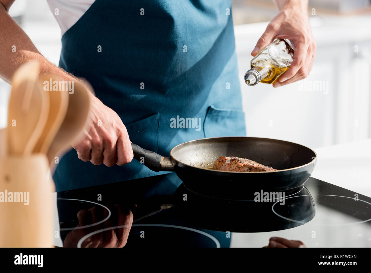 partial view of man pouring oil on steak Stock Photo - Alamy