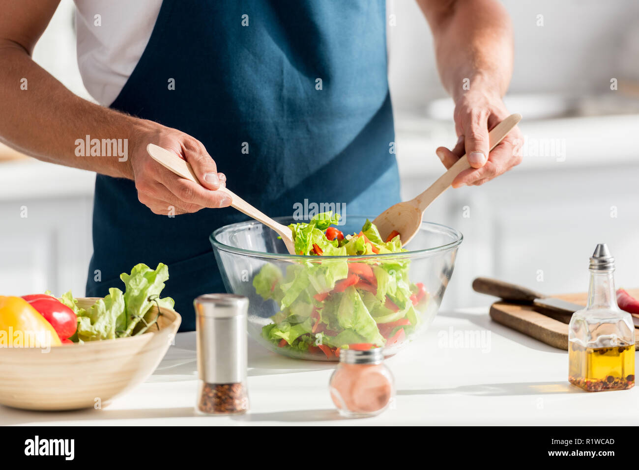 partial view of male cooker mixing salad Stock Photo - Alamy