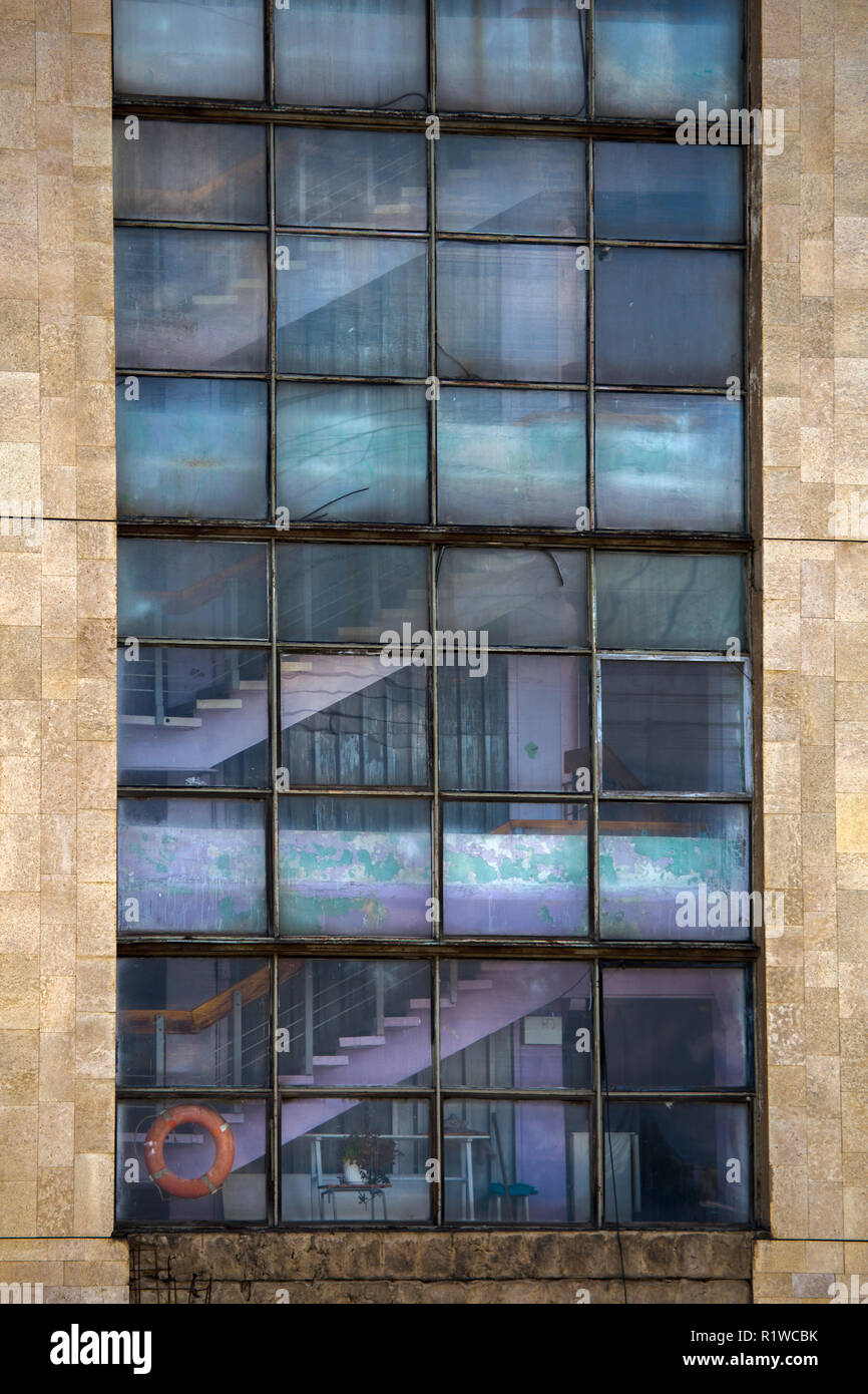 View of a staircase behind windows in industrial building Stock Photo ...