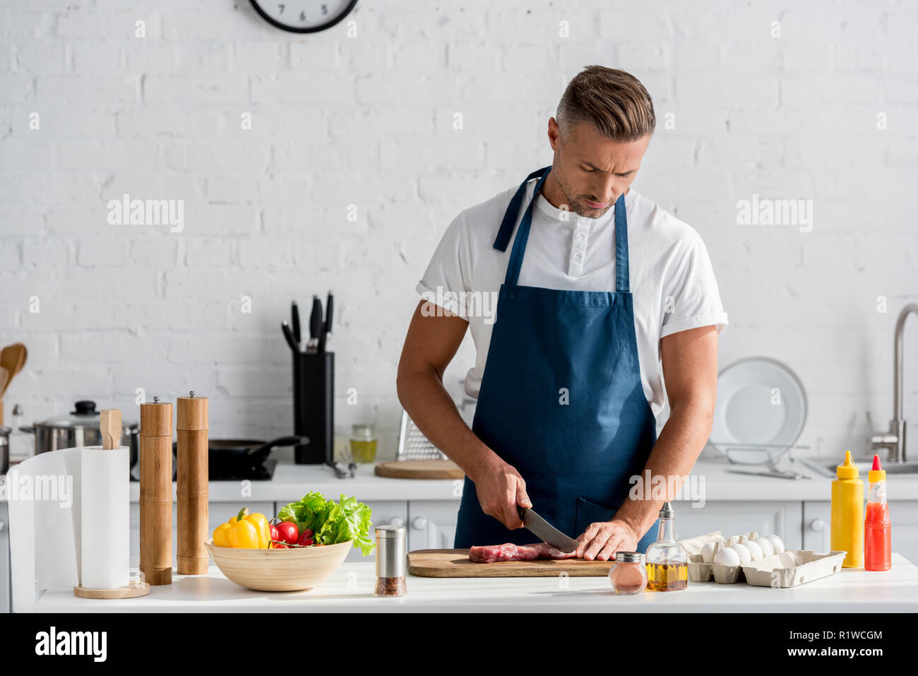 Man cutting meat hi-res stock photography and images - Alamy