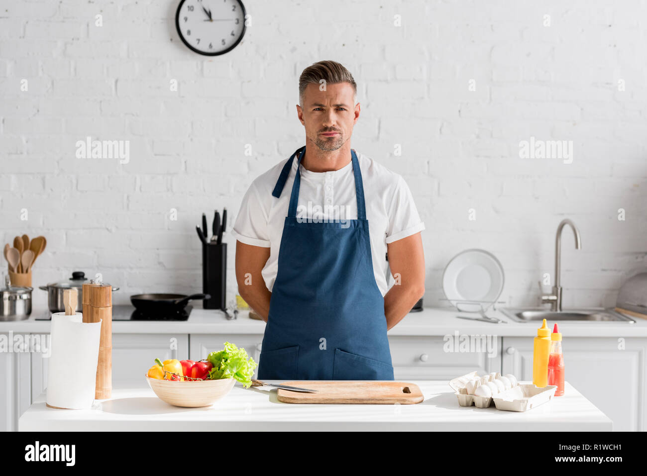 Man in kitchen looking saucepan hi-res stock photography and images - Alamy