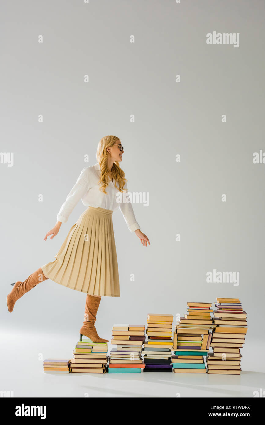 attractive adult woman posing on pile of retro books Stock Photo - Alamy