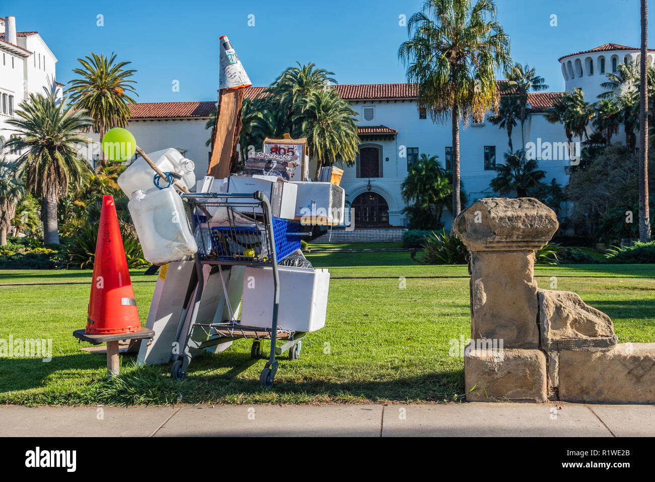 A shopping cart loaded with belongings of a homeless person, parked in ...