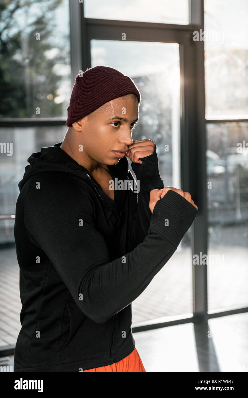 side view of young african american boxer exercising at gym Stock Photo ...