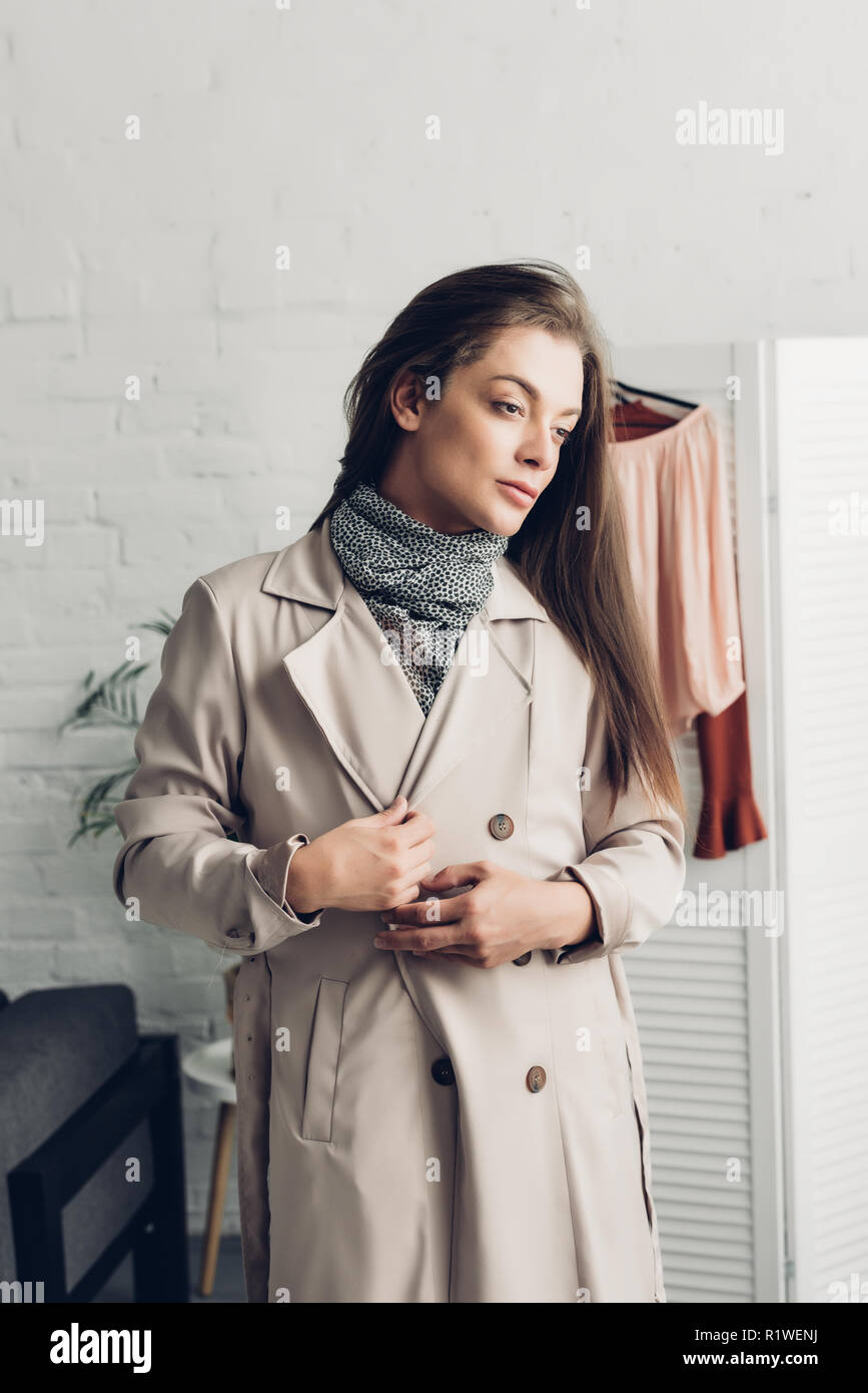 stylish young transgender man in trench coat at home Stock Photo - Alamy