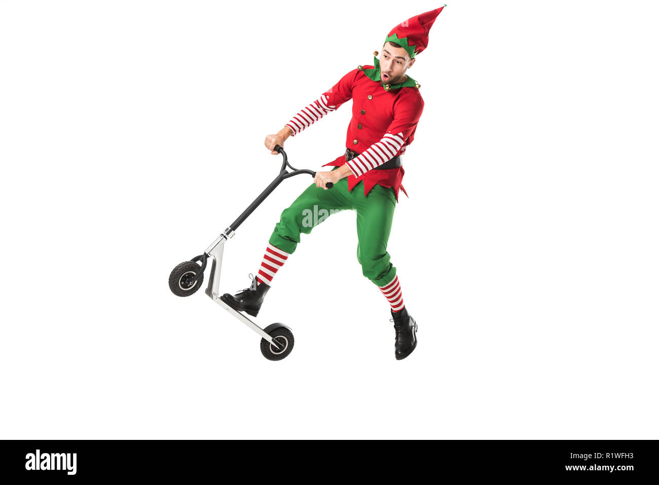excited man in christmas elf costume jumping in air on push-cycle ...
