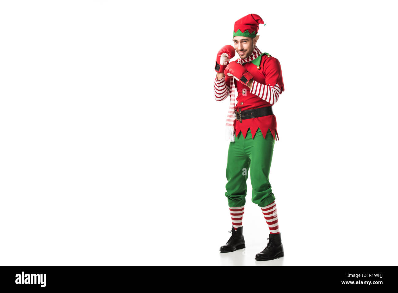 man in christmas elf costume wearing red boxing gloves and ready for ...