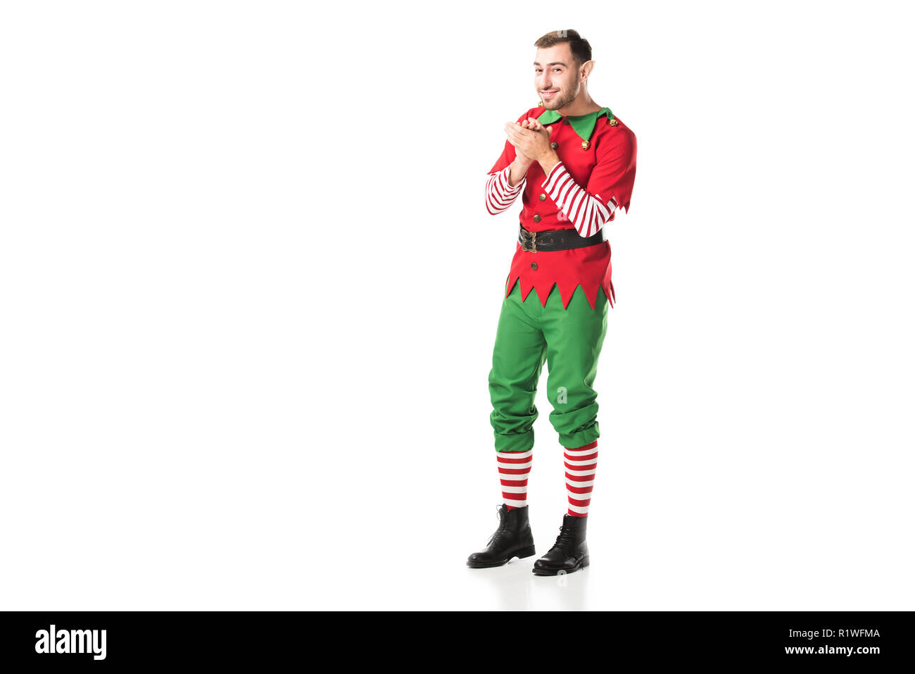excited smiling man in christmas elf costume looking at camera and ...