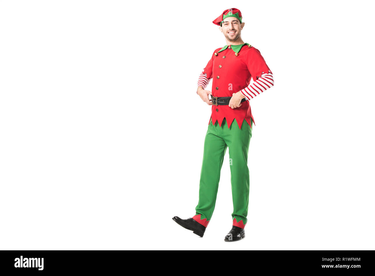 smiling man in christmas elf costume looking at camera with hands on ...