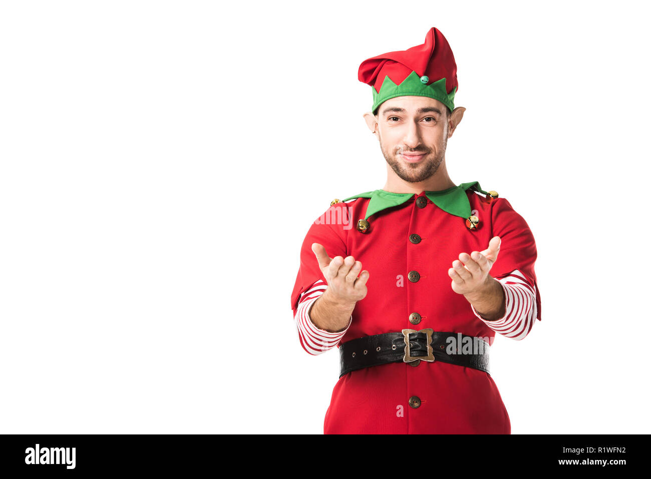 man in christmas elf costume with outstretched hands gesture looking at ...