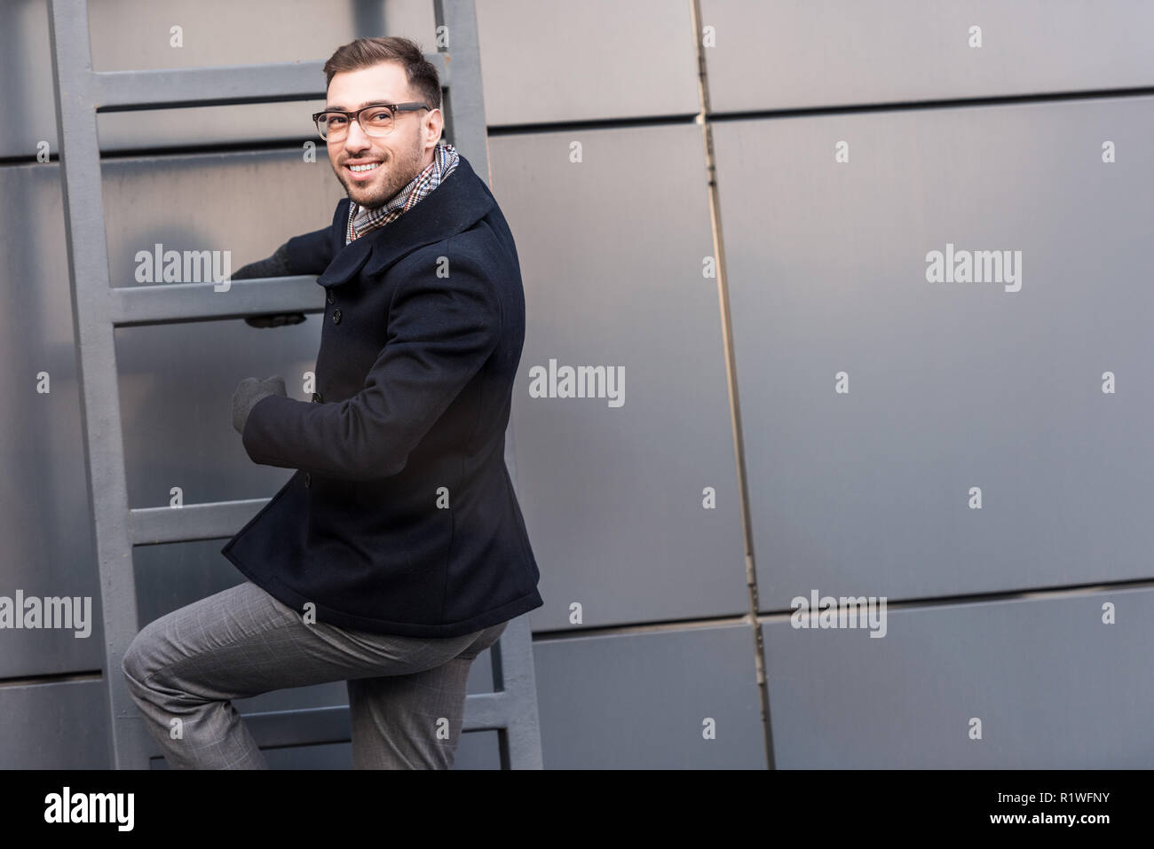 Man climbing ladder building hi-res stock photography and images - Alamy