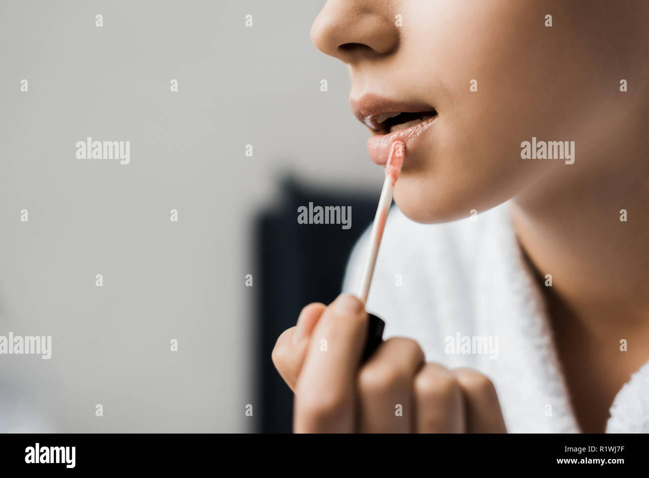 Girl applying lip gloss hi-res stock photography and images - Alamy