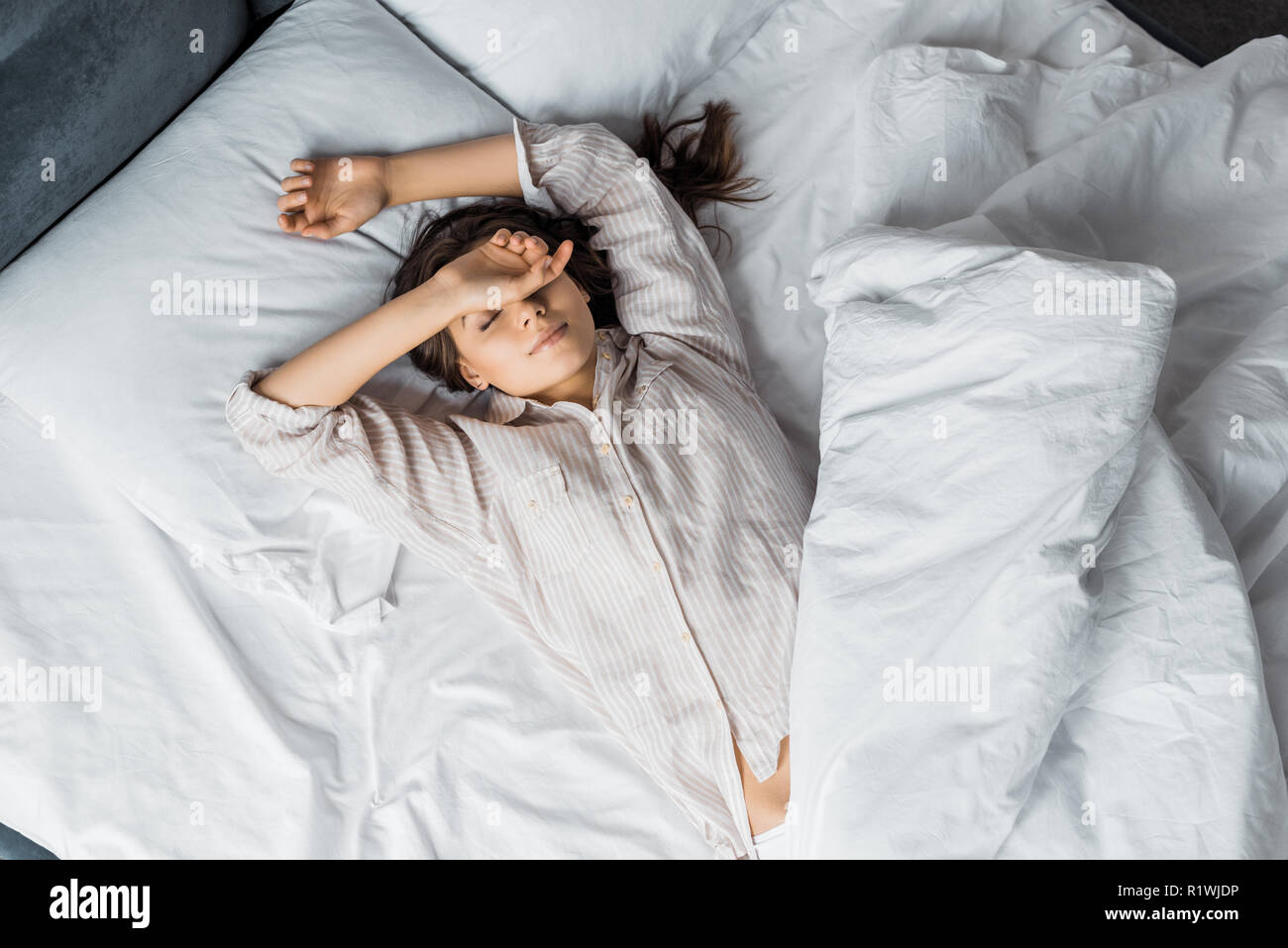 top view of beautiful happy girl sleeping on bed in the morning Stock ...