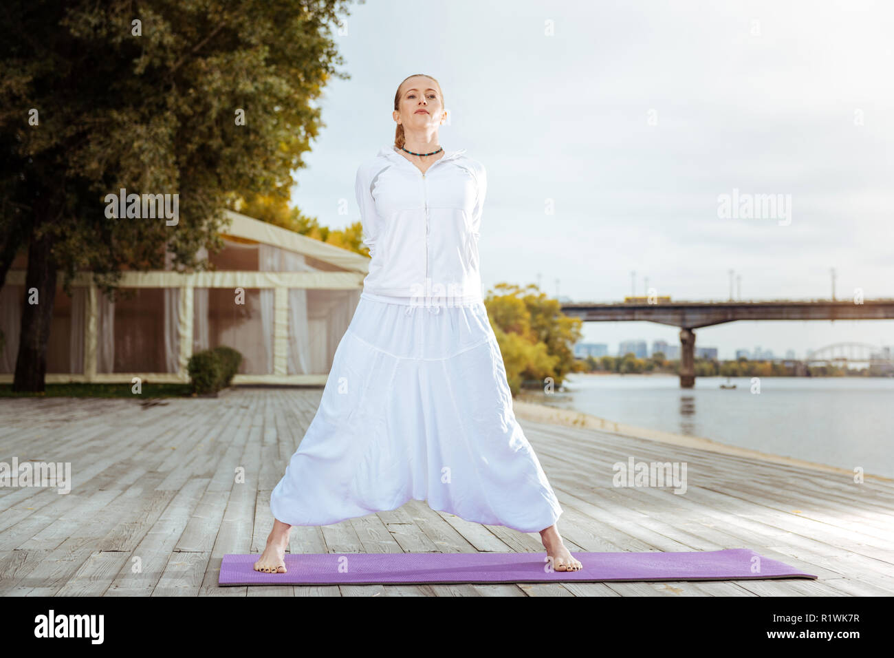 Woman stretching her back muscles with yoga exercises Stock Photo - Alamy
