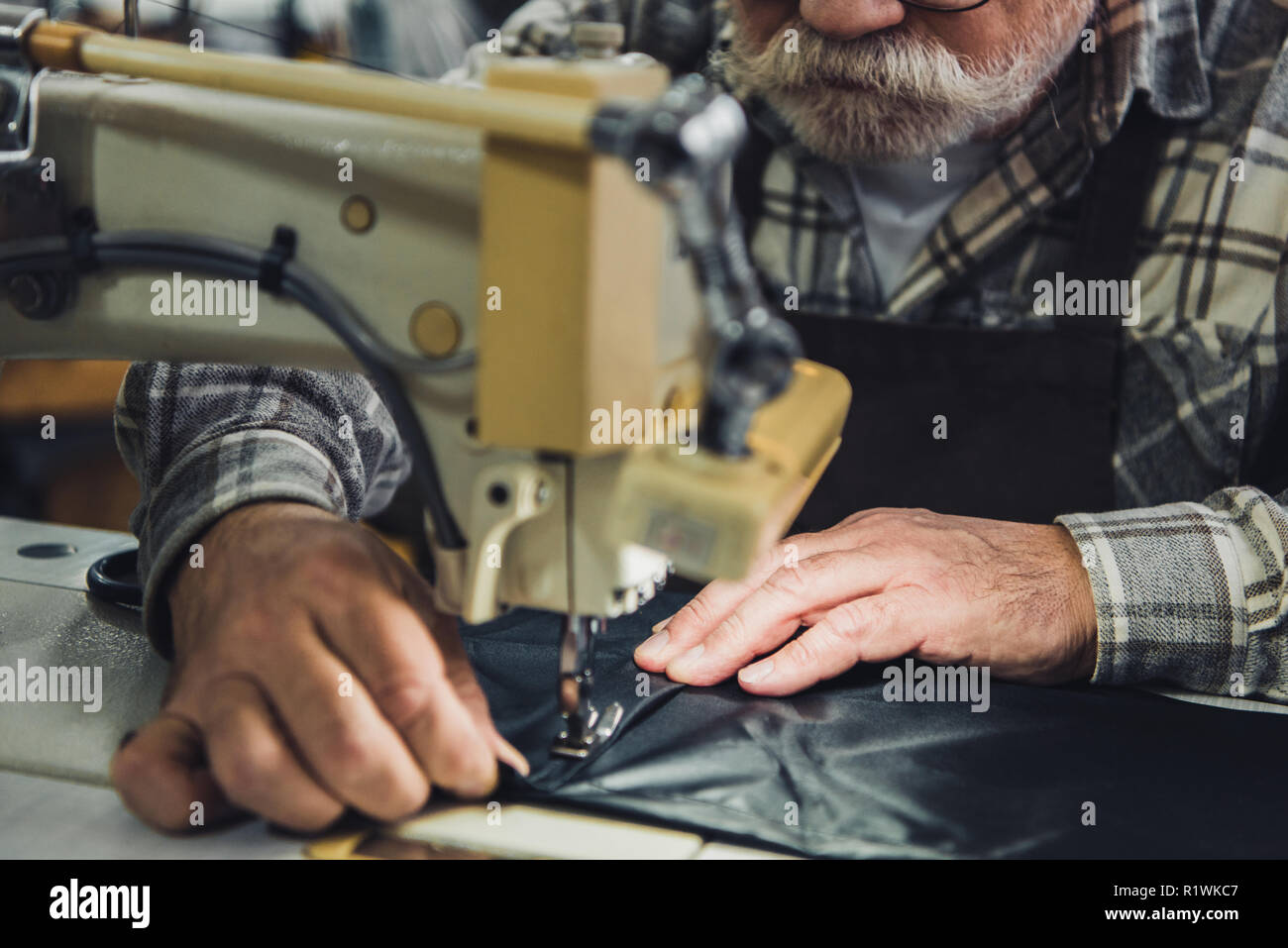 Man working in workshop sewing machine hi-res stock photography and ...