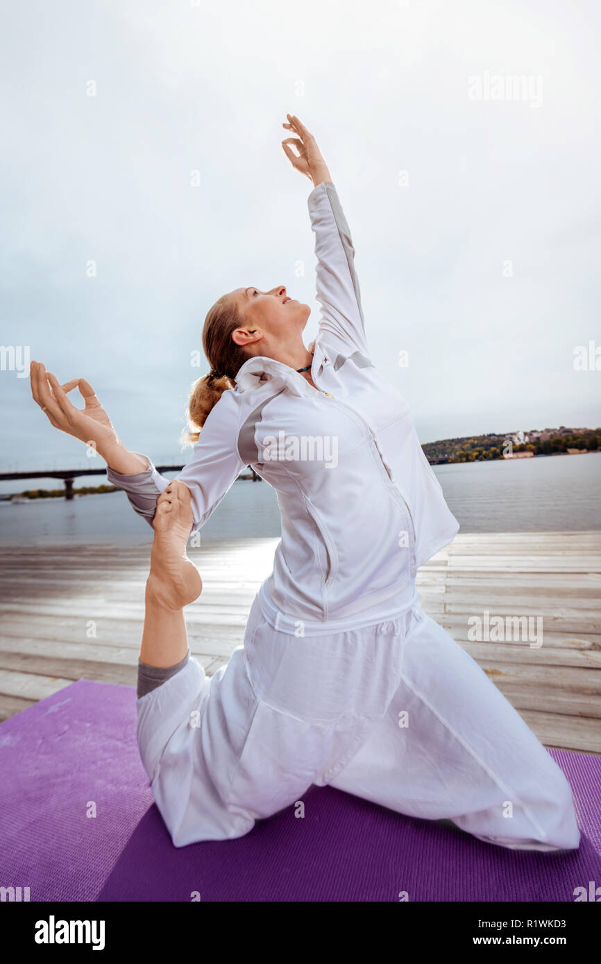 Concentrated female yogist practising asanas in the morning Stock Photo ...