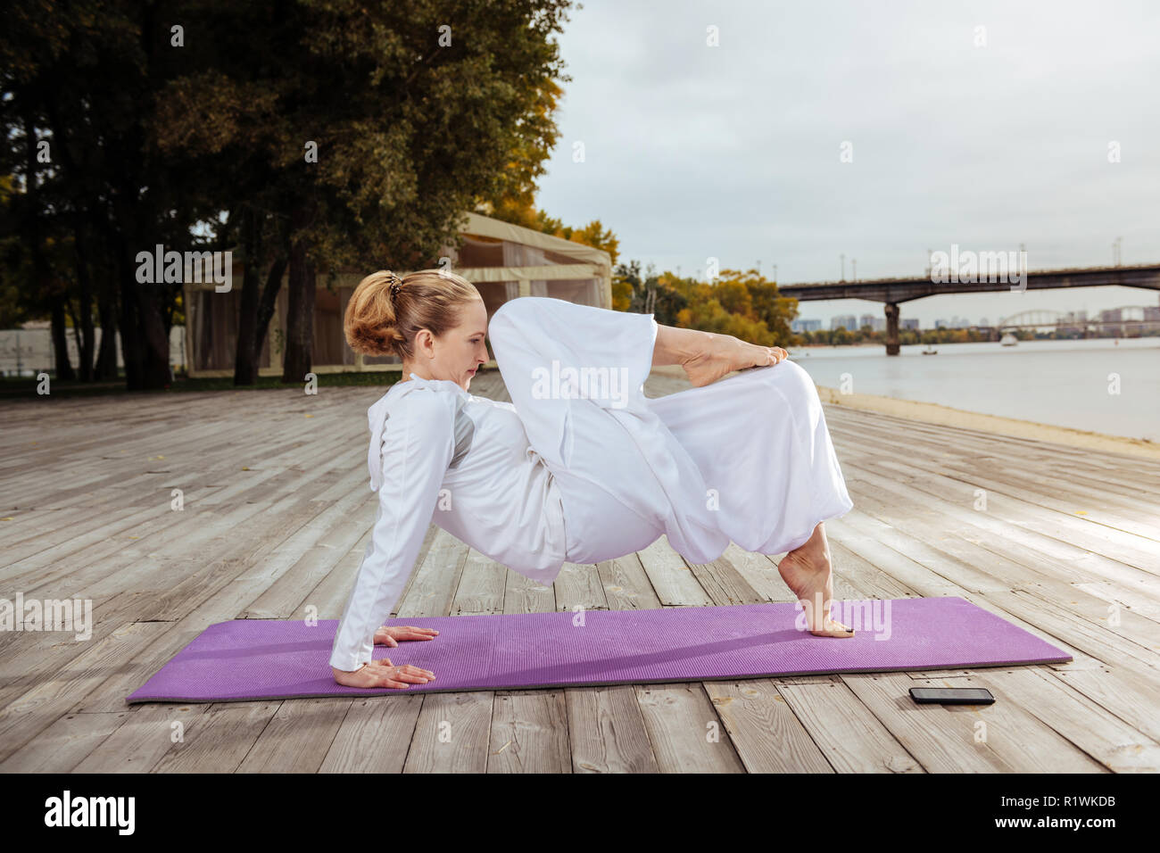 Female yogist easily practising complicated yoga pose Stock Photo - Alamy