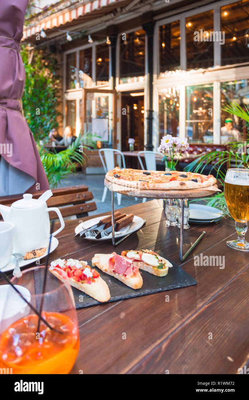 Italian cafe with tables in the street Stock Photo - Alamy