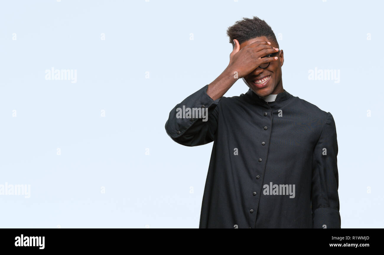 Young african american priest man over isolated background smiling and ...