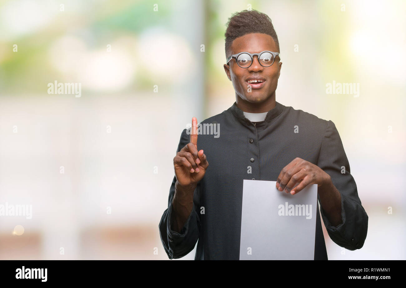 Young african american priest man over isolated background holding ...