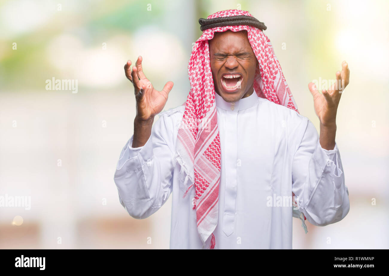 Young arabic african man wearing traditional keffiyeh over isolated ...