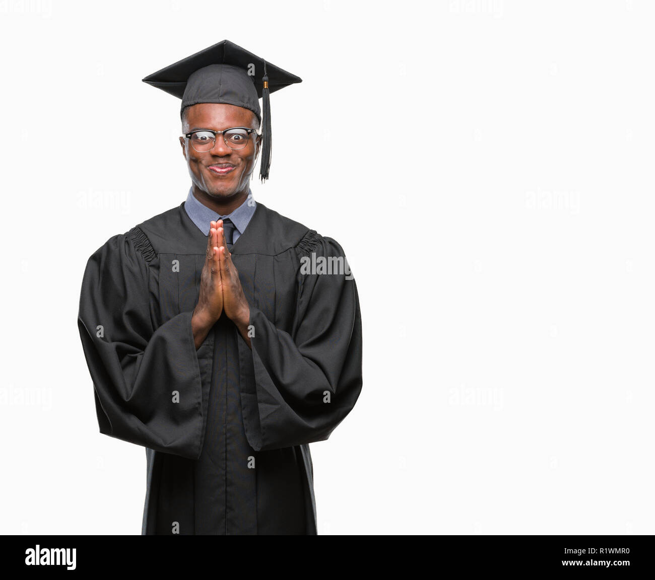 Young graduated african american man over isolated background praying ...