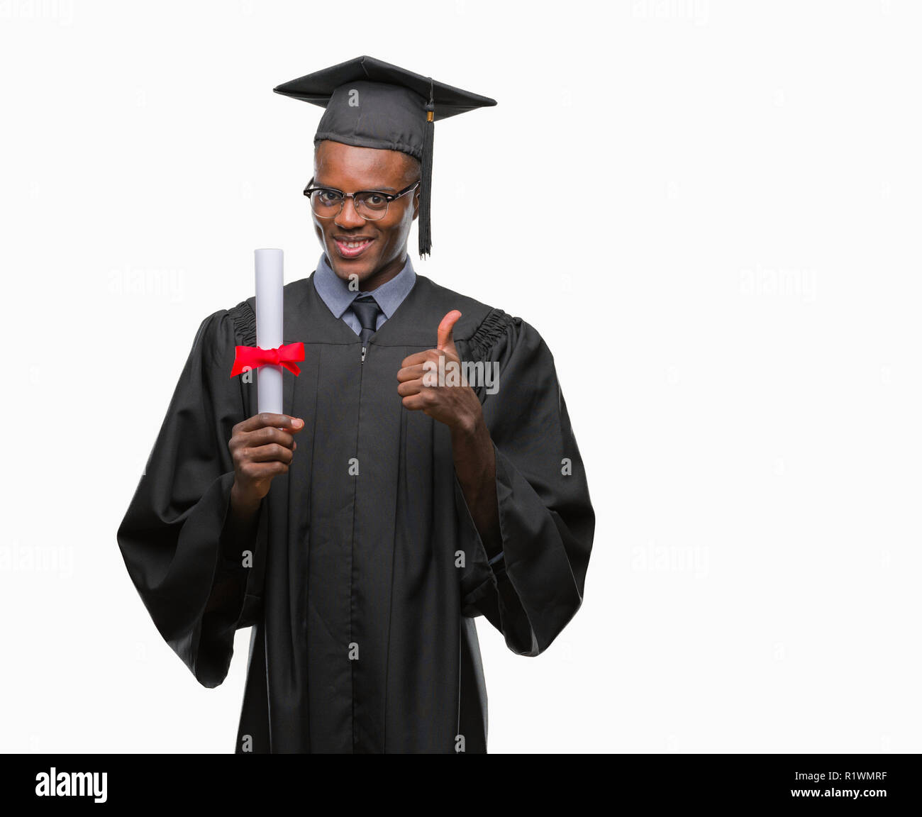 Young graduated african american man holding degree over isolated ...