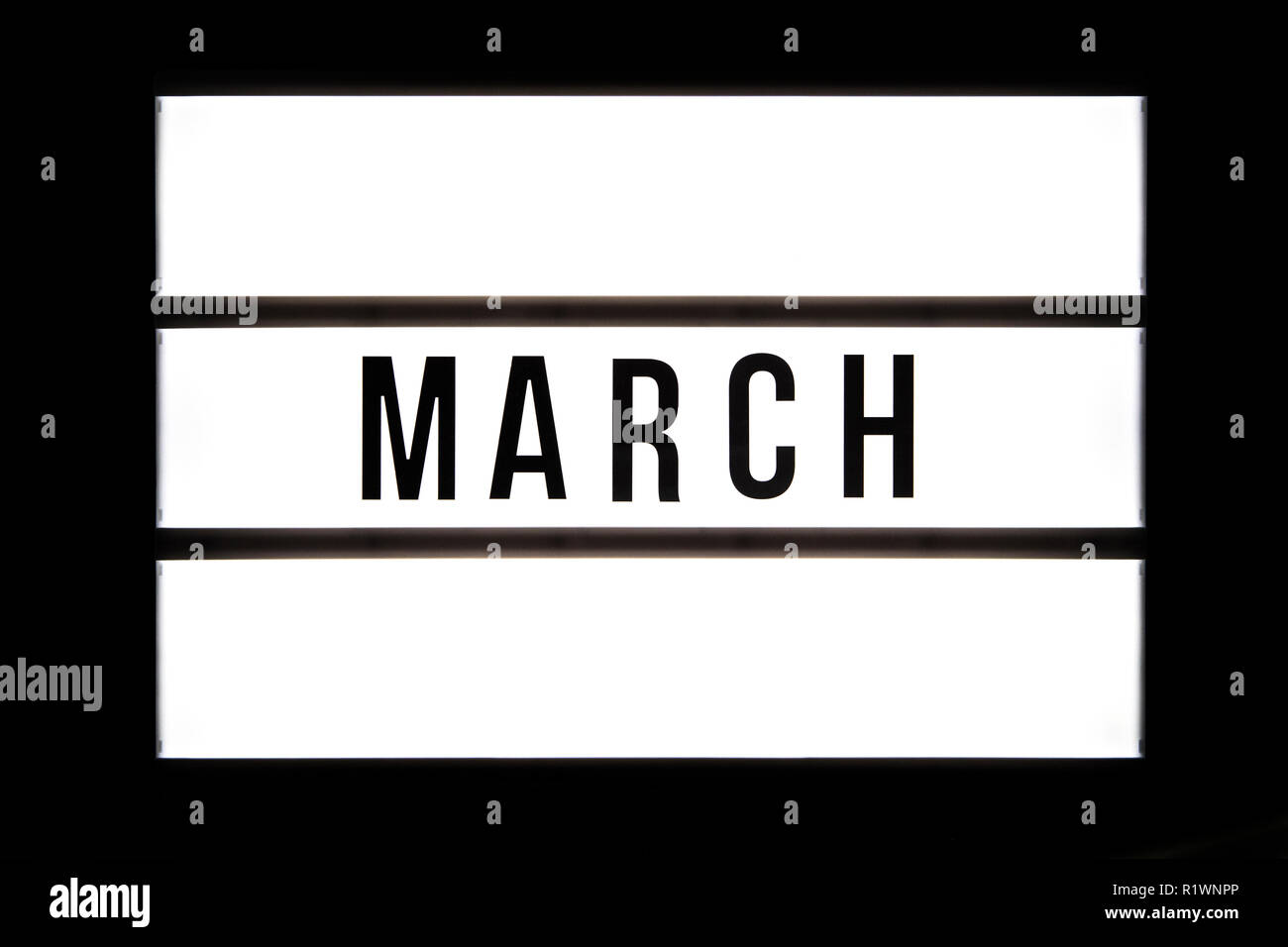 MARCH text in a light box, isolated over a black background Stock Photo ...