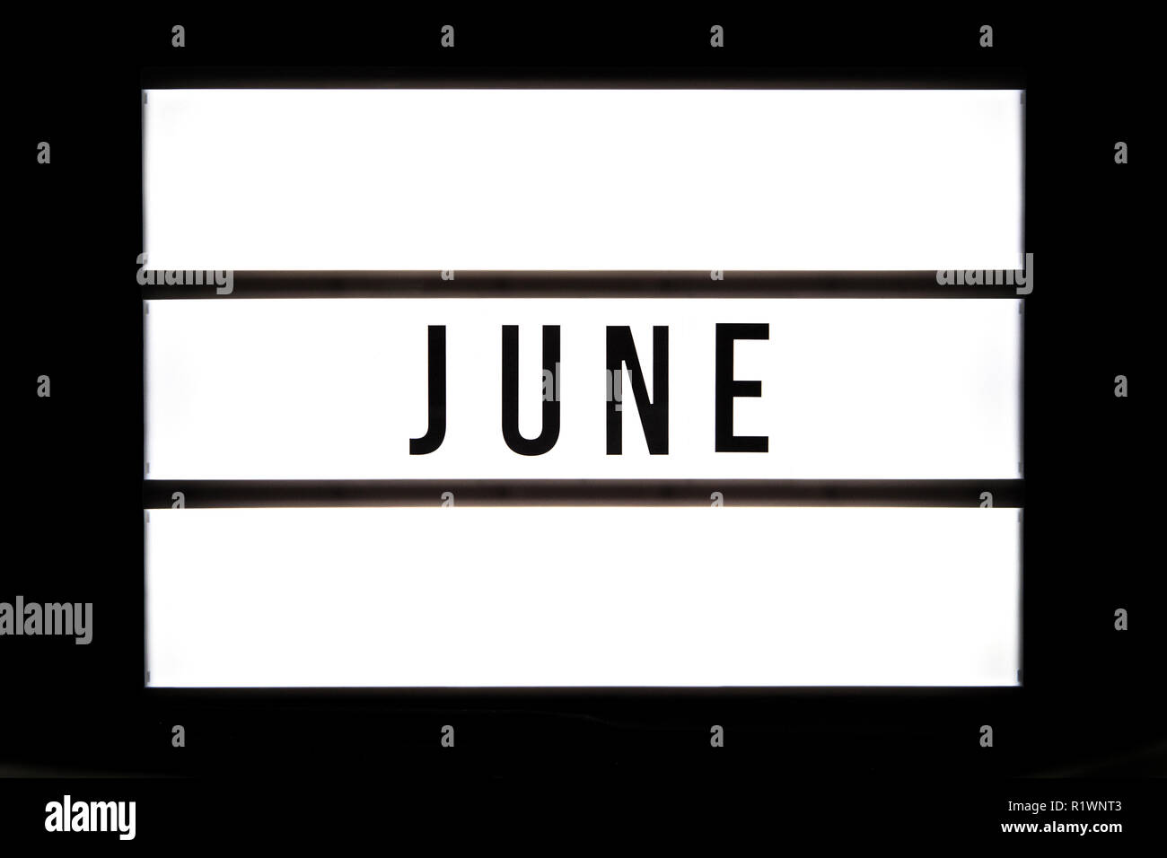 JUNE text in a light box, isolated over a black background Stock Photo ...