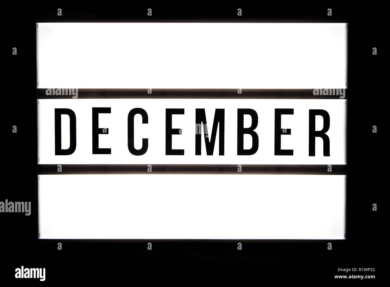 DECEMBER text in a light box, isolated over a black background Stock ...