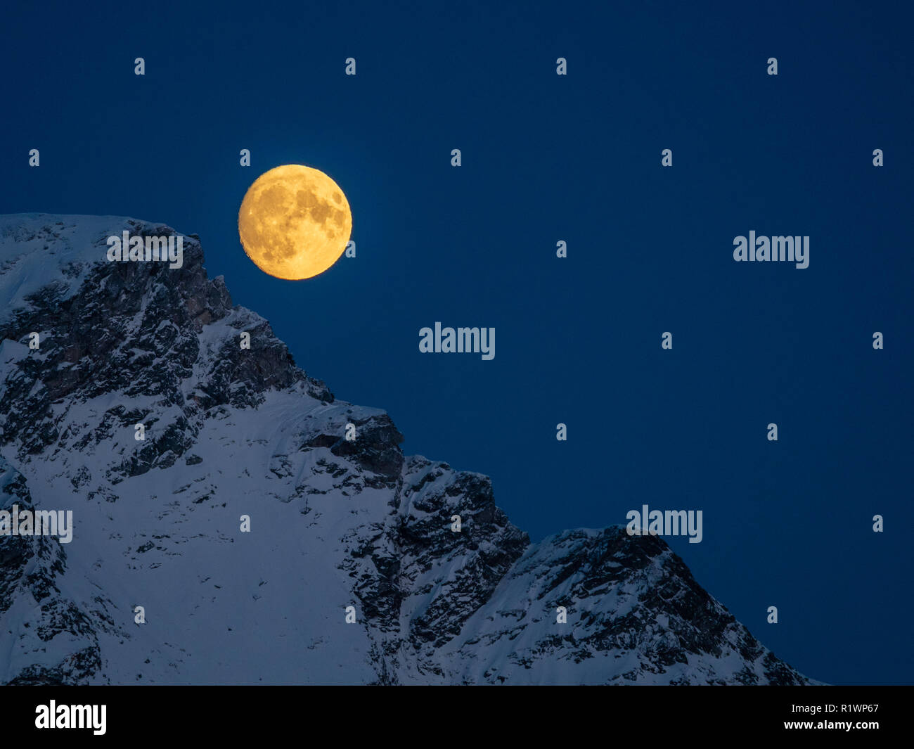 Full moon over the mountains Stock Photo - Alamy